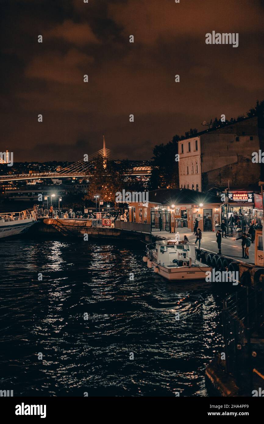 Night view of Istanbul city with boats on water, vintage old building ...
