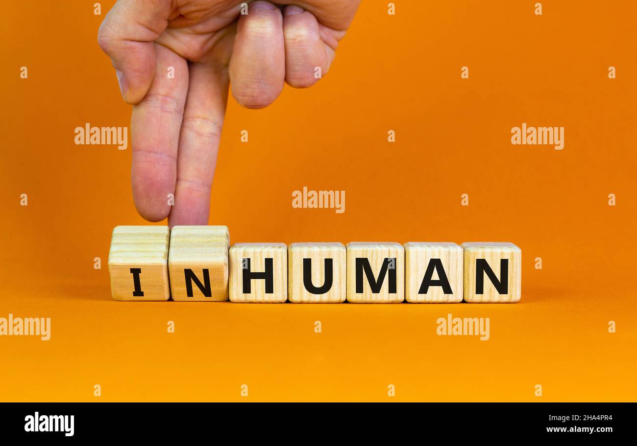 Human or inhuman symbol. Businessman turns wooden cubes and changes the ...