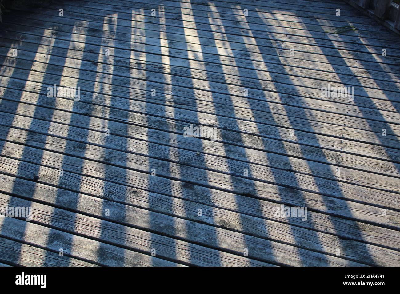Parallel shadows falling over perpendicular wooden planks Stock Photo ...