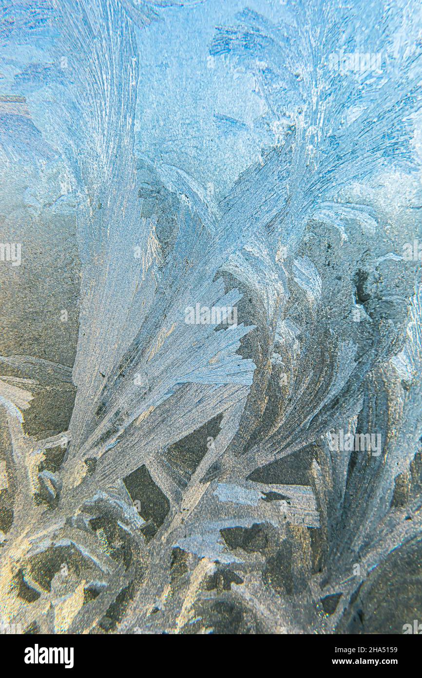 Frozen winter window with shiny ice frost pattern texture. Christmas ...
