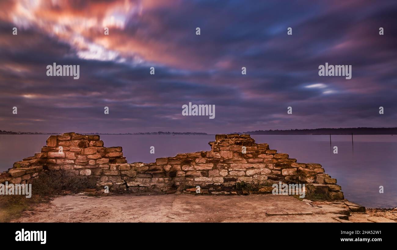 Ruined brick wall facing the sea on the sunset Stock Photo - Alamy