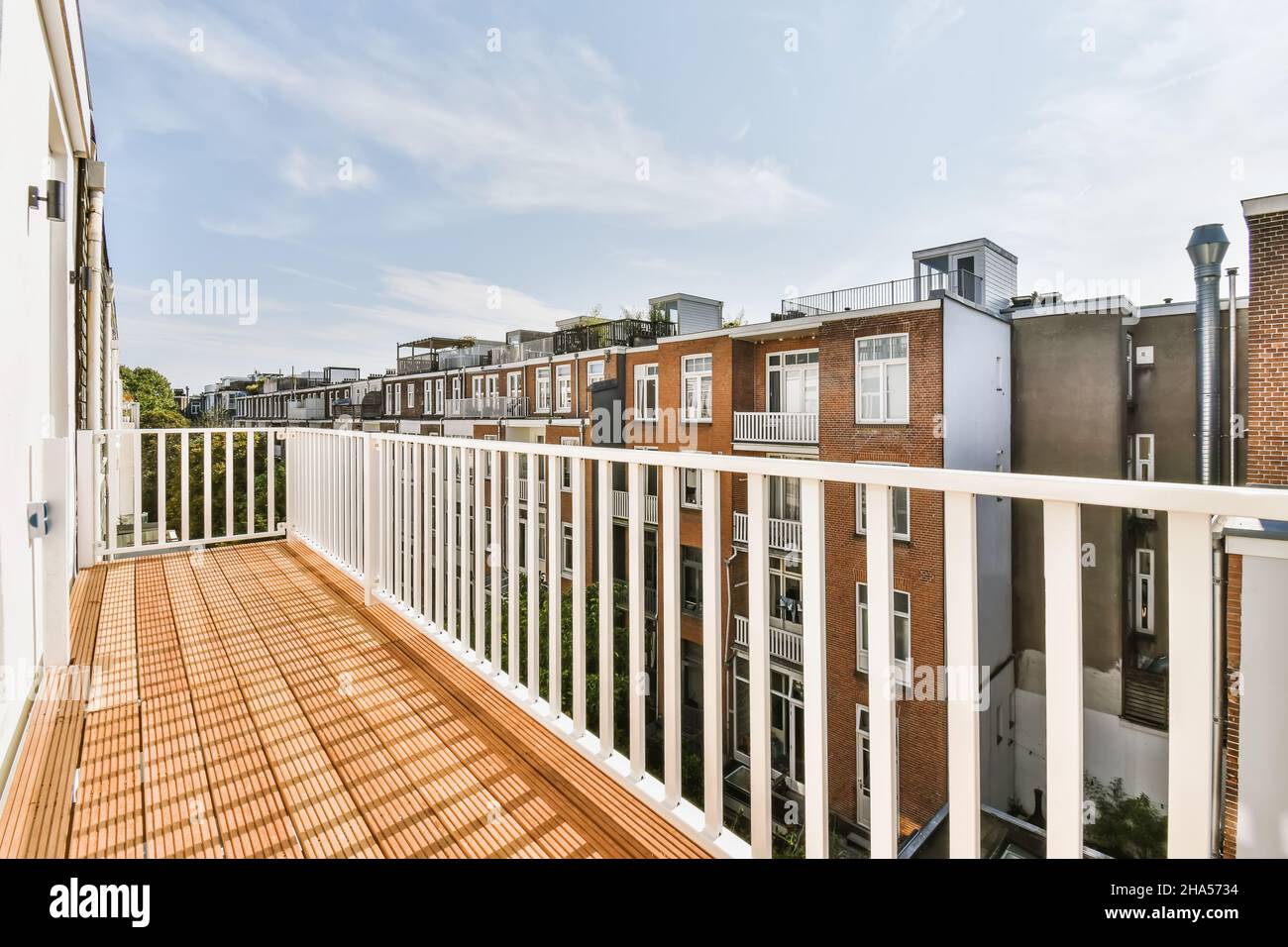 Long cozy balcony in a luxury house Stock Photo - Alamy