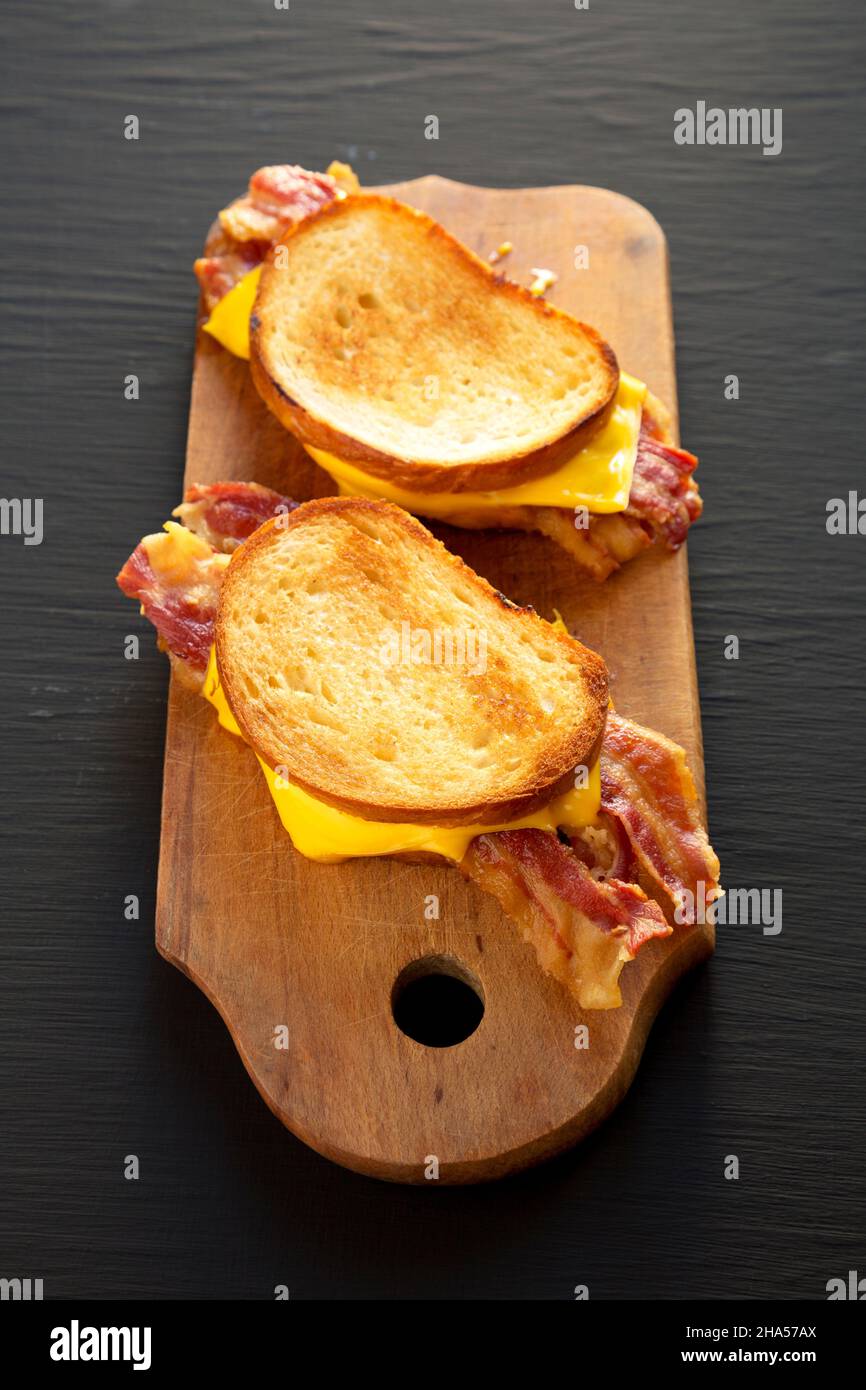 Homemade Bacon Grilled Cheese Sandwich on a rustic wooden board on a ...