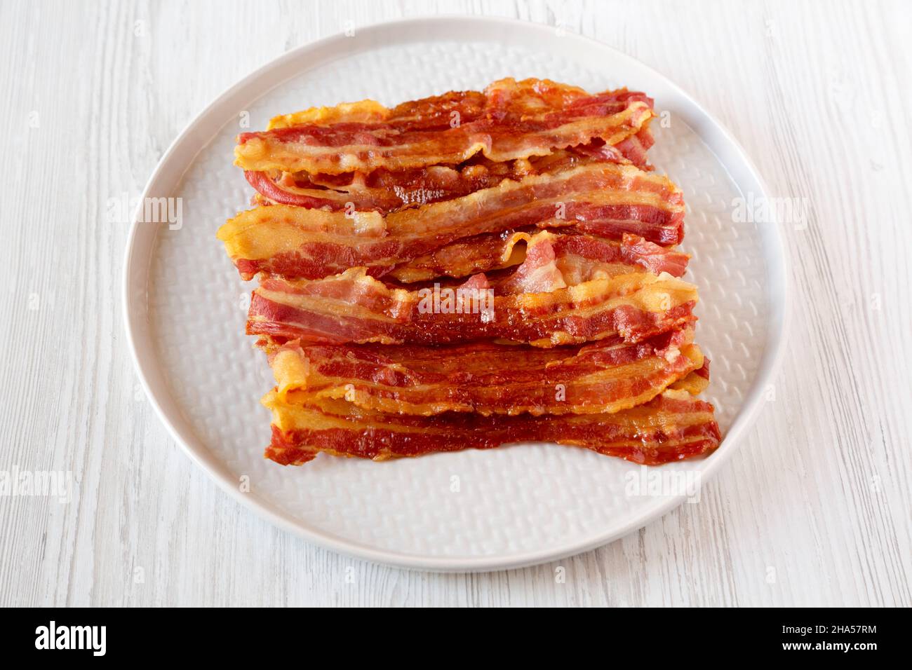 Homemade Oven Baked Bacon on a Gray Plate, side view Stock Photo - Alamy