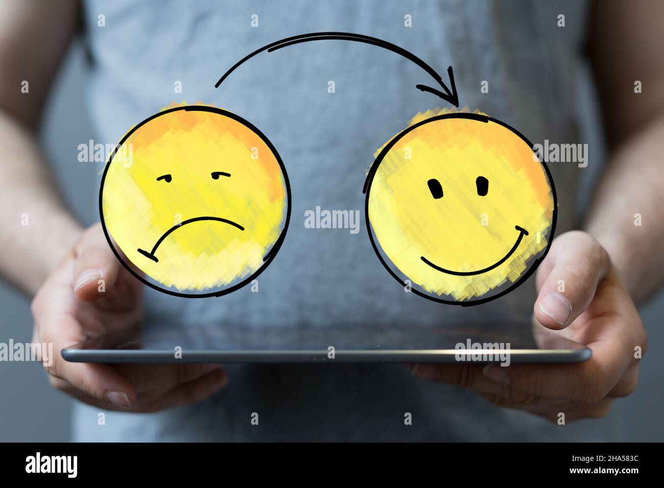 3D rendering of smiley faces over a tablet; happy and unhappy mood ...