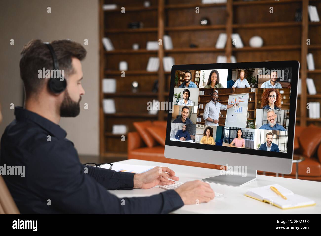 Virtual conference with employees. Young man in formal clothes using pc ...