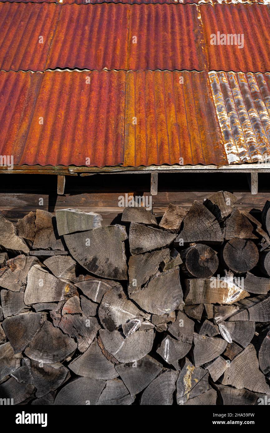Rusty Roof and Stacked Fire Wood Stock Photo - Alamy