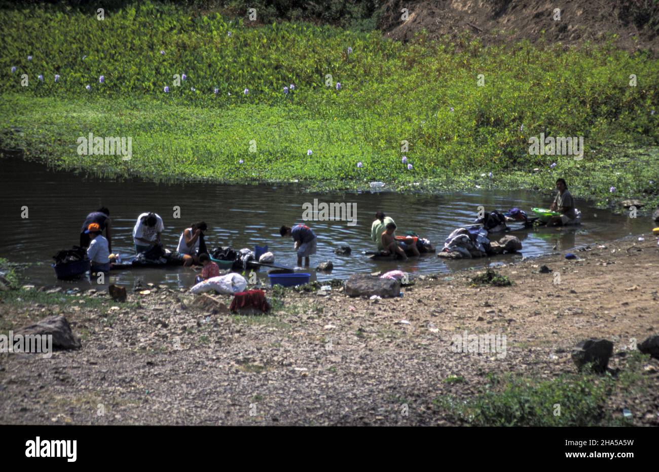 Women washing cloths hi-res stock photography and images - Alamy
