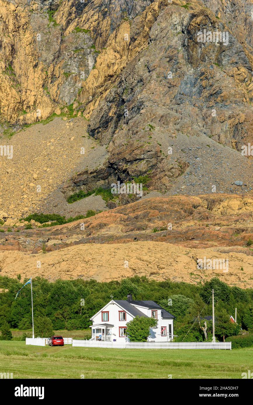 House in front of cliff with serpentinite and olivine stone, Leka ...