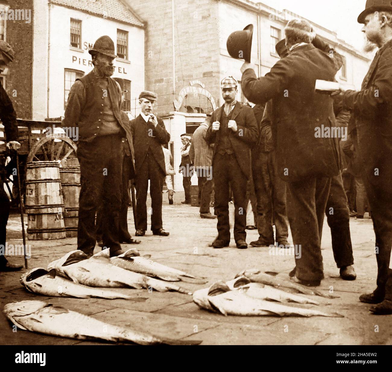 Selling fish on the quayside, Whitby, Victorian period Stock Photo - Alamy