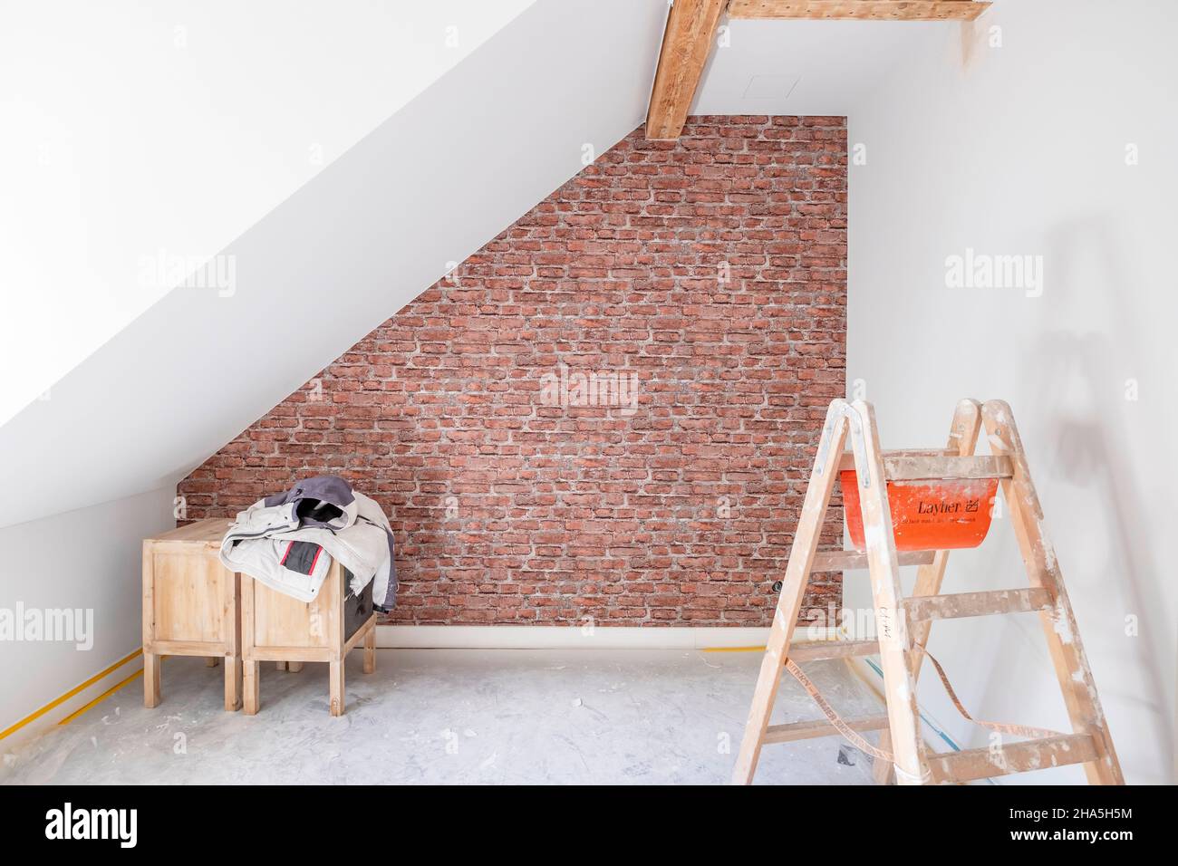 Empty room in the attic with brick motif wallpaper hi-res stock ...