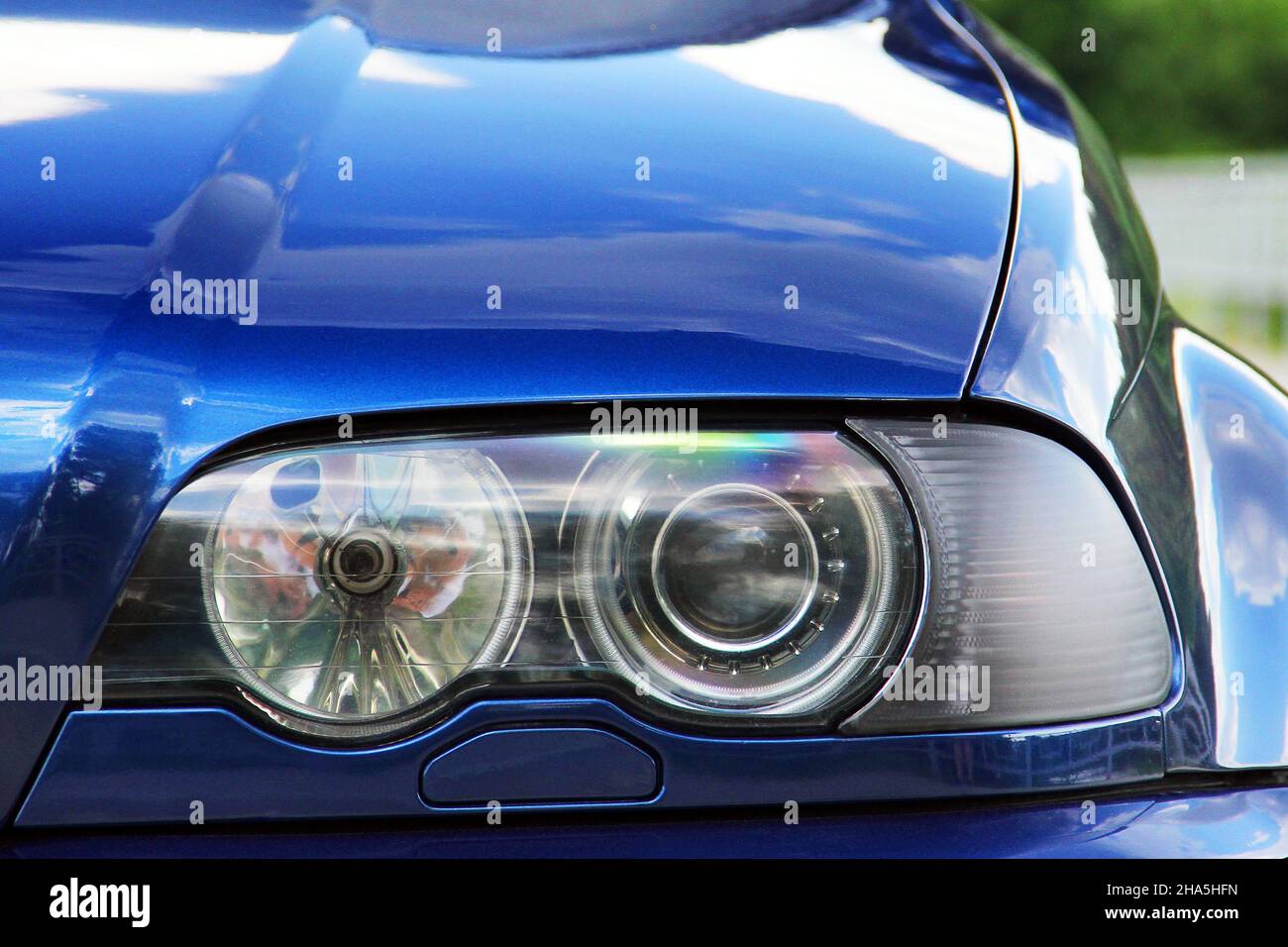 Car headlights. Luxury Headlights. Part of a blue car Stock Photo - Alamy