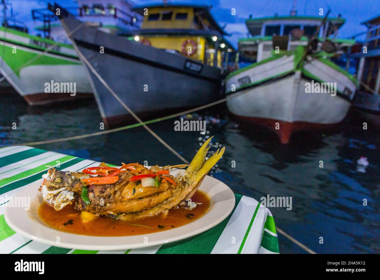 Fish dish at a seafood restaurant at the night market in Kota Kinabalu ...