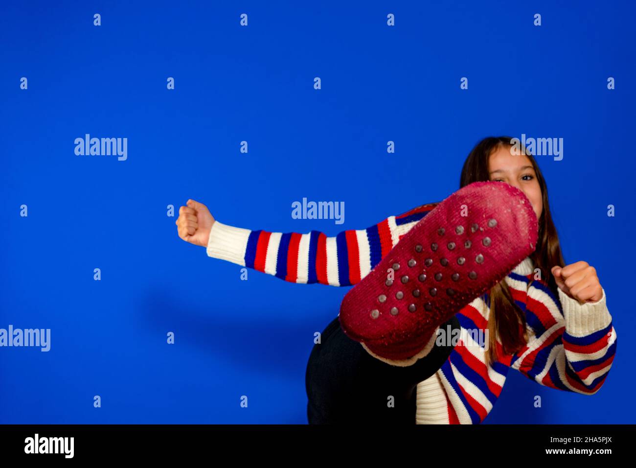 Pretty Spanish preteen girl throwing a self defense front kick. She ...