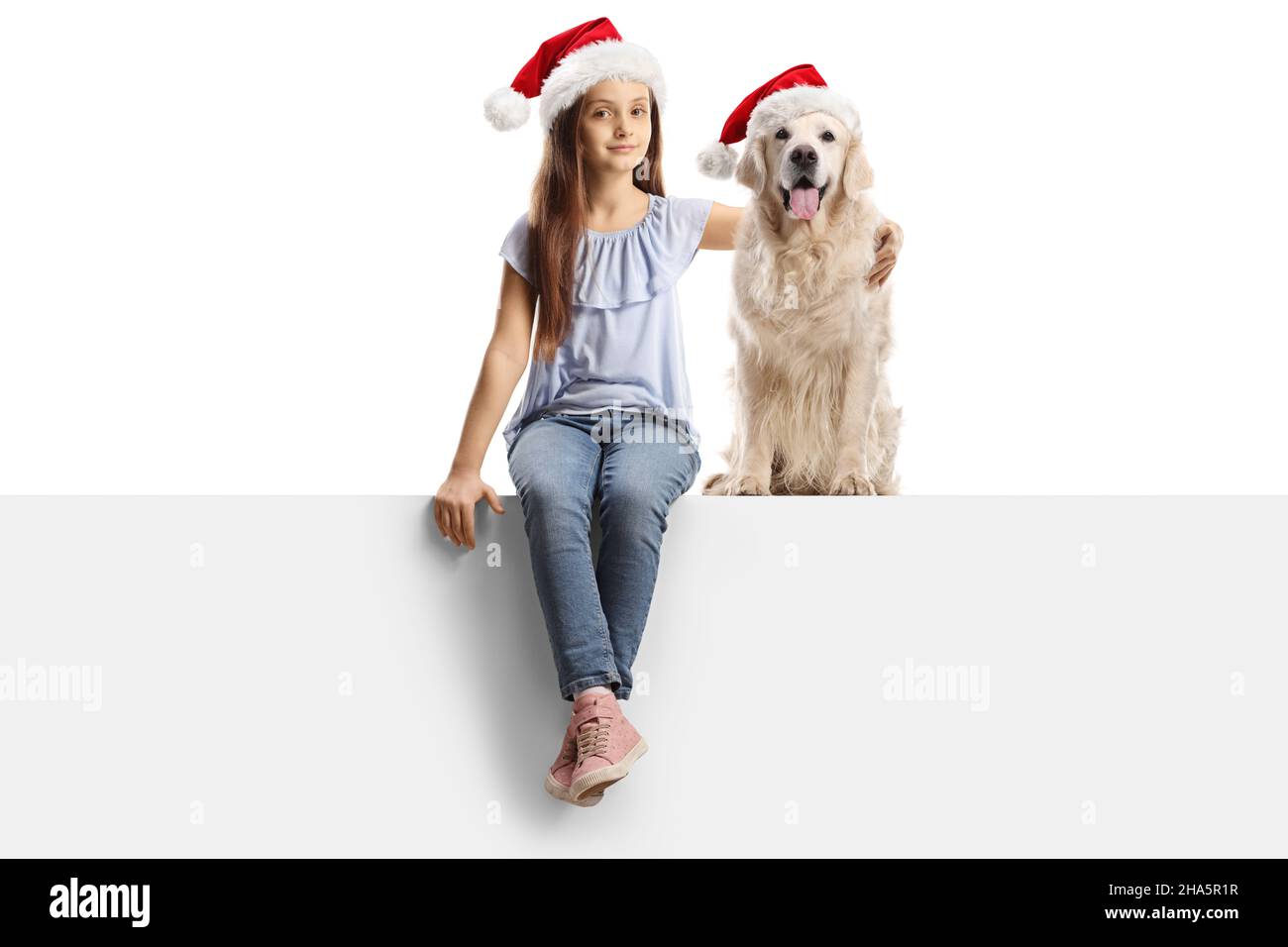 Girl hugging a labrador retriever dog with christmas santa claus hat ...