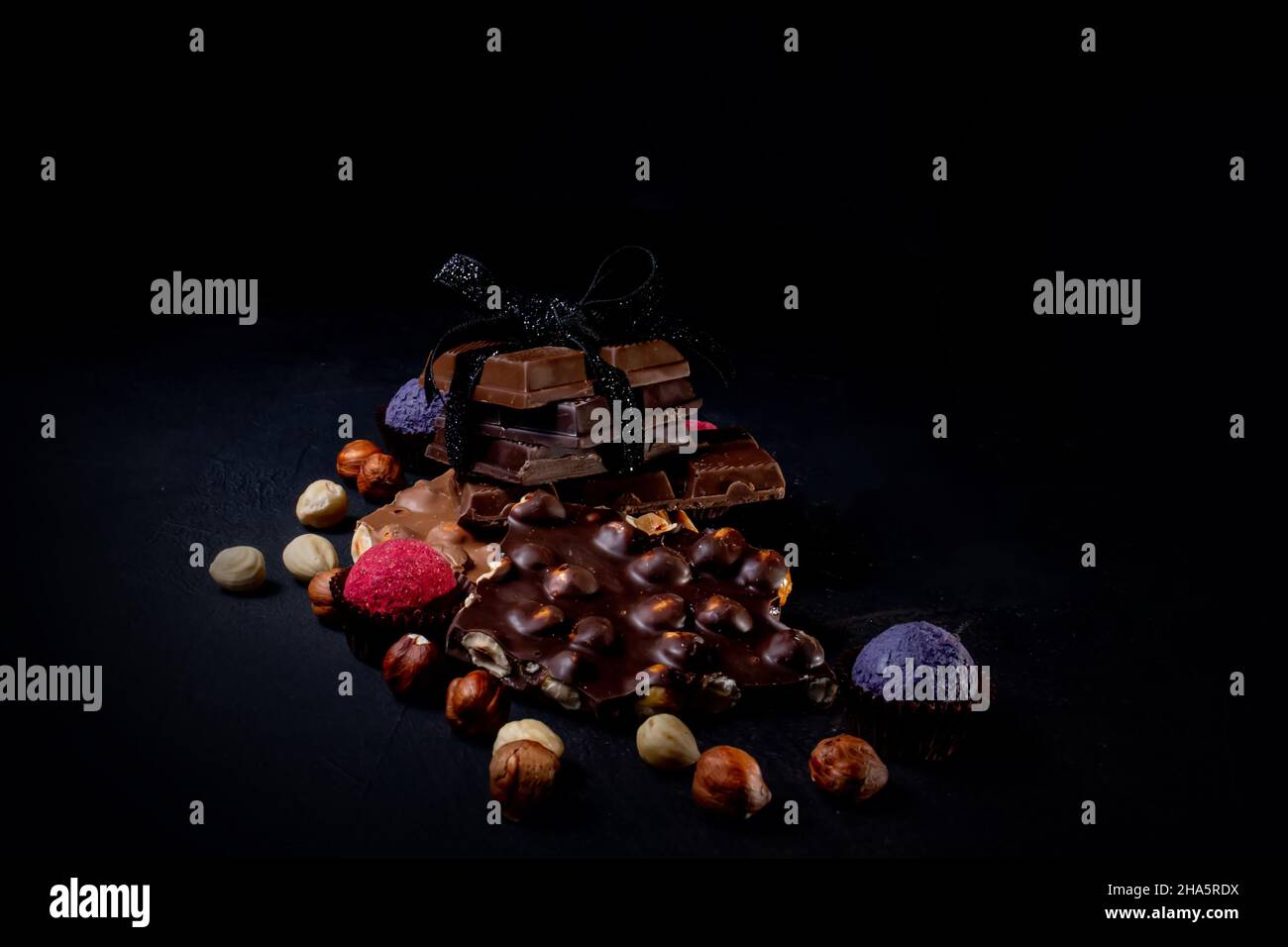 Chocolate bar, crushed pieces of dark chocolate and nuts. Praline ...