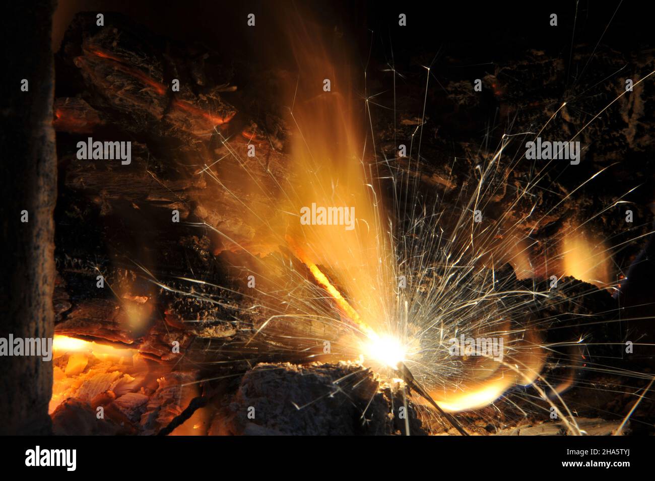 Fireworks dropped in the fireplace, sparkling Stock Photo - Alamy
