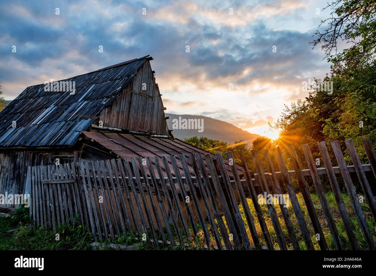 Beautiful country landscape with green trees on hill and rural houses ...