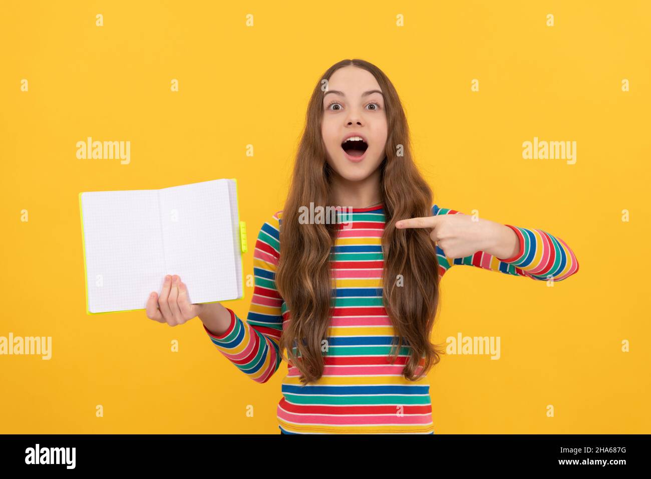 Take a look read a book. Surprised girl point finger at open book. Read ...