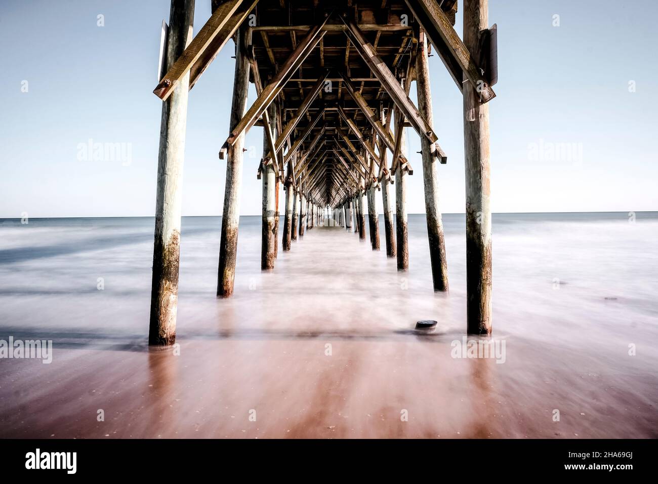 Seaside Next To A Long Pier Stock Photo - Alamy
