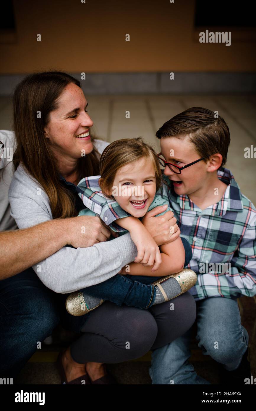 Family Hugging & Smiling for Camera in San Diego Stock Photo - Alamy