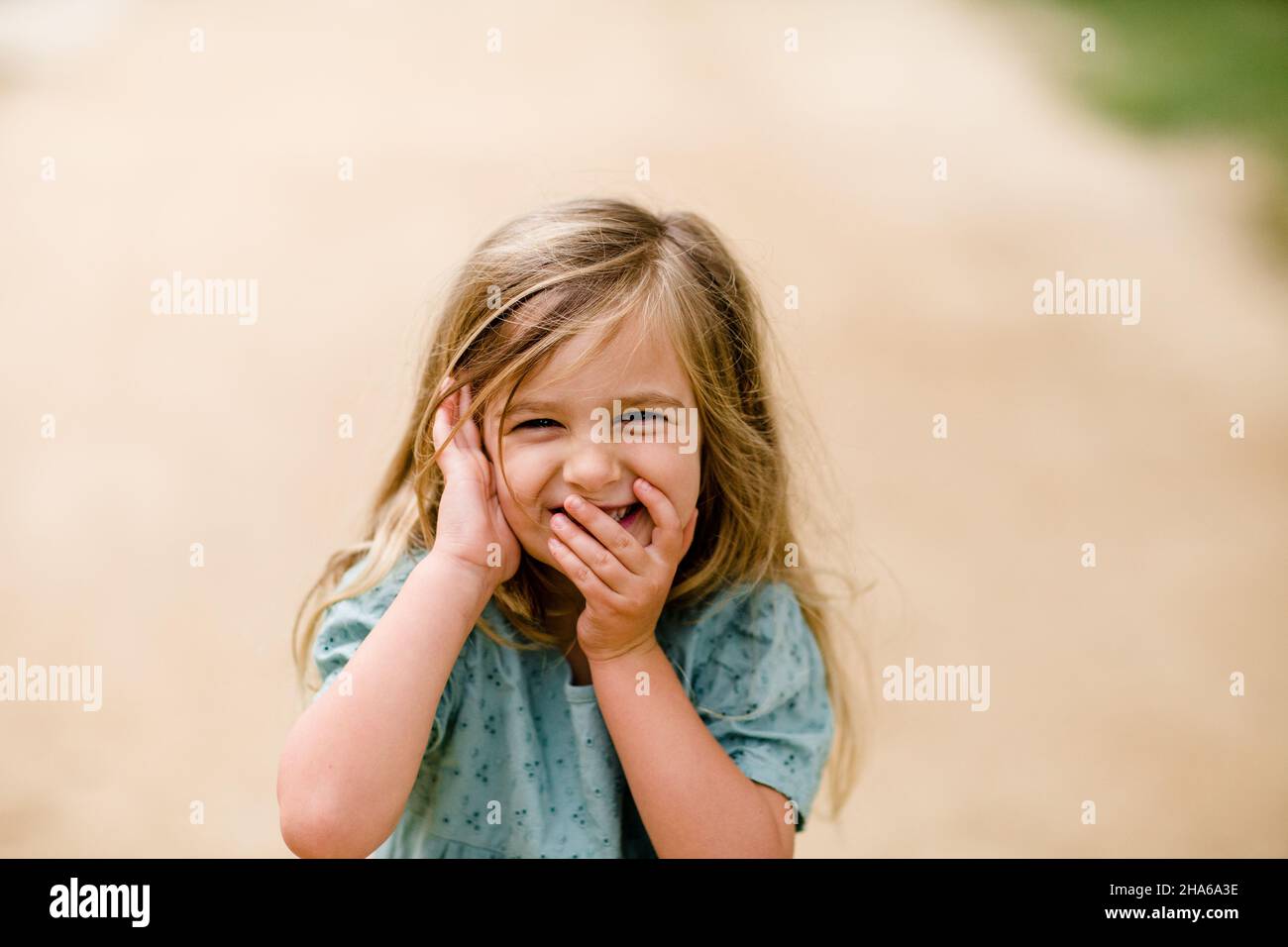 Four Year Old Touching Face & Giggling in San Diego Stock Photo - Alamy
