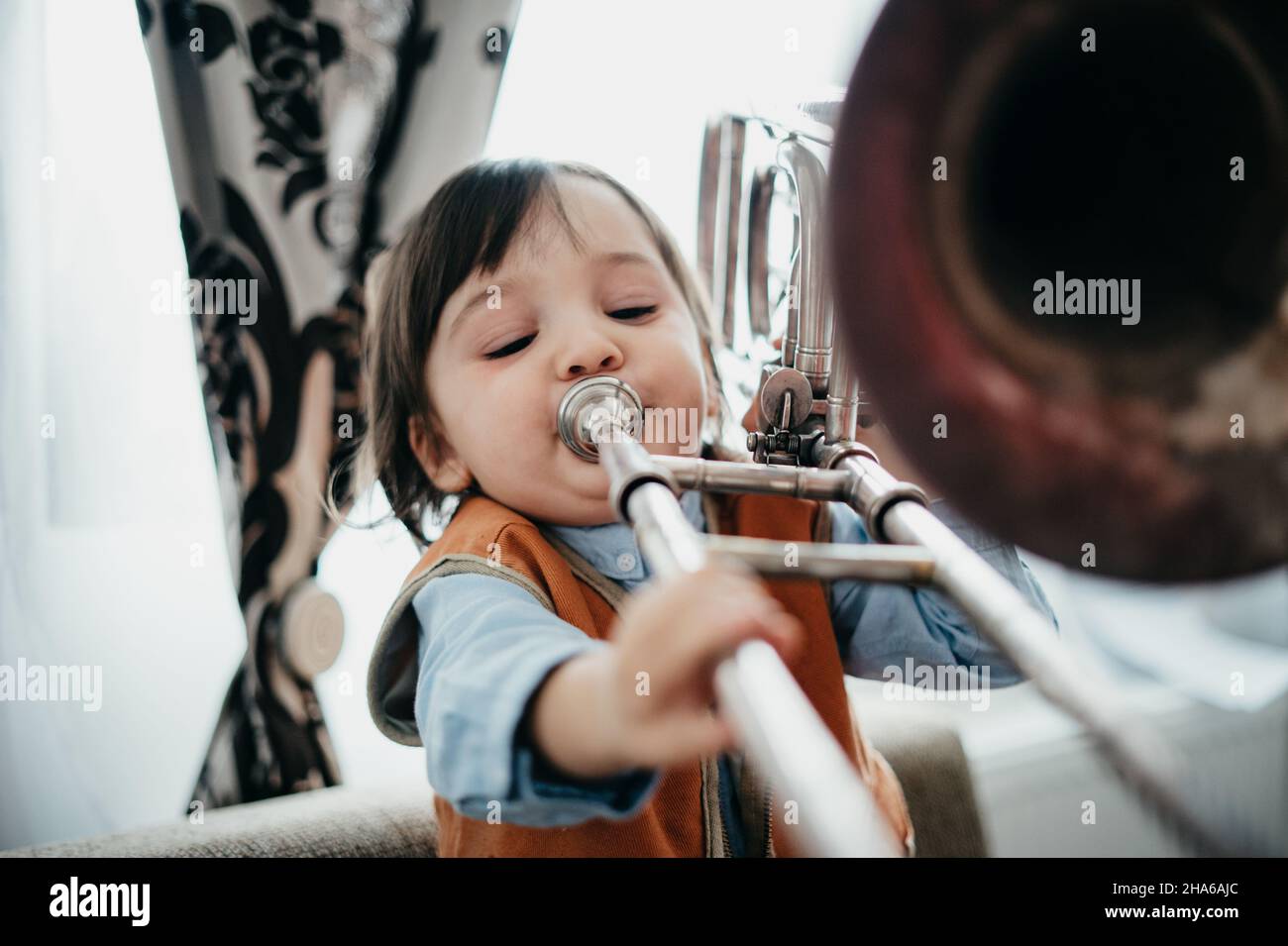 Young boy learns to play the trombone Stock Photo - Alamy