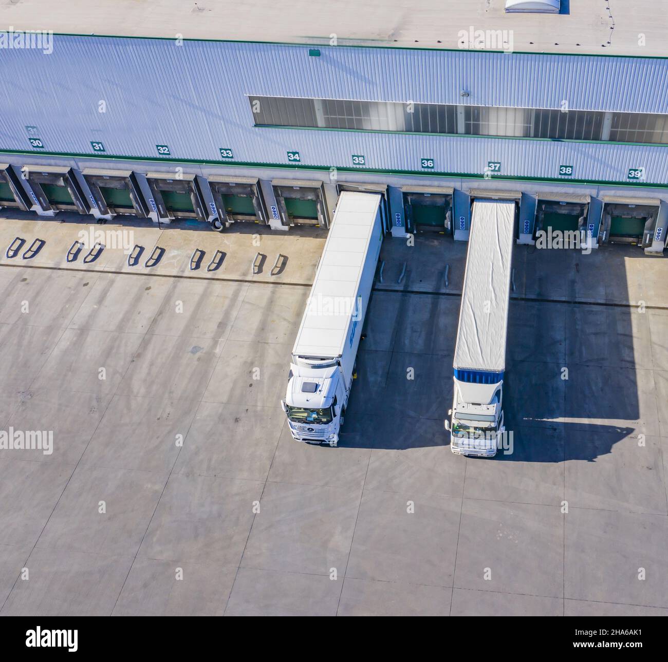 Truck while loading in a big distribution warehouse. Aerial View Stock ...