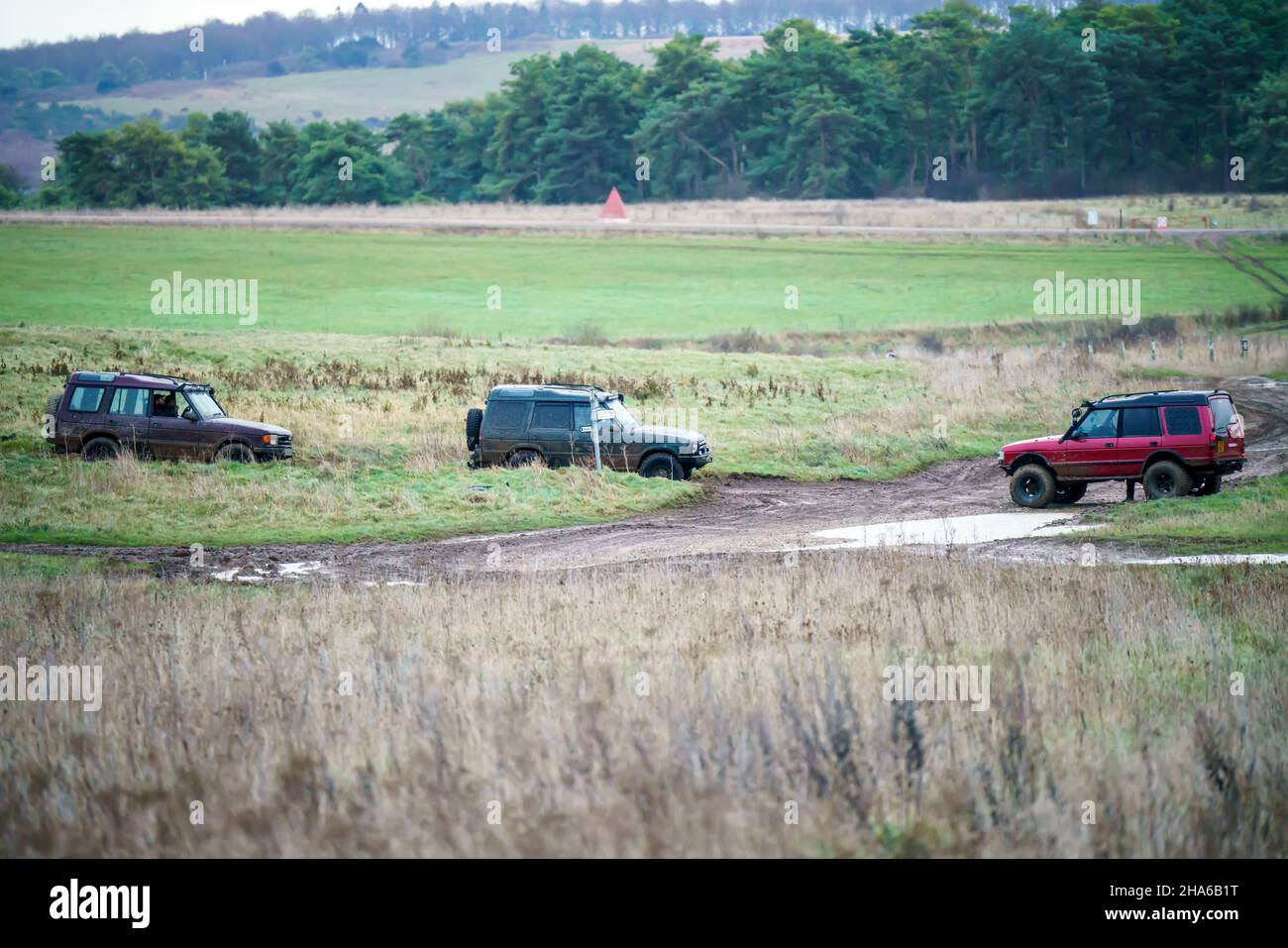 4x4 off-road vehicles driving across mud and water-logged terrain ...