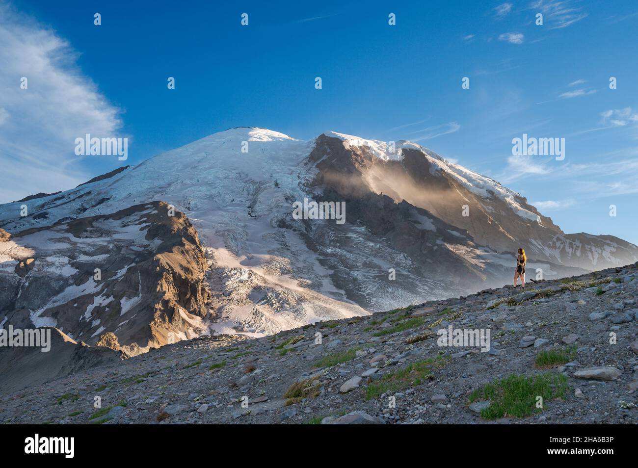 Fit female standing on a ridge next to Mount Rainier Stock Photo - Alamy