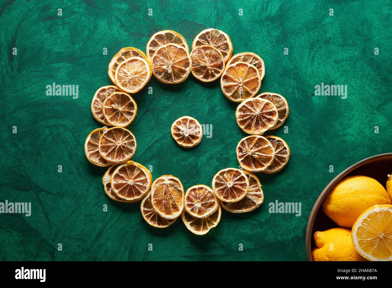 Dried Lemons on a Green Background with Fresh Lemons in a Wooden Bowl ...