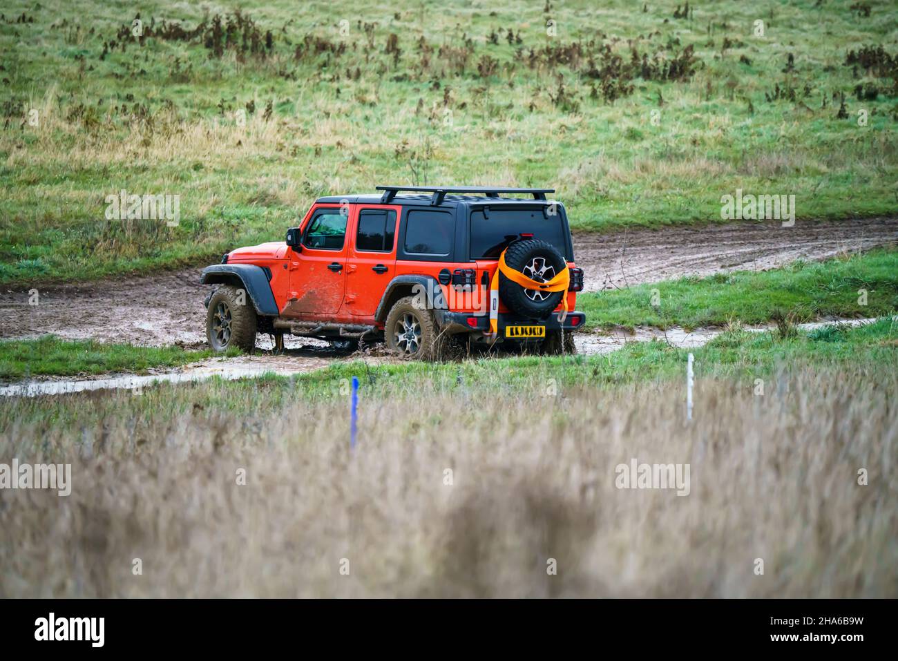 4x4 off-road vehicle driving across mud and water-logged terrain ...