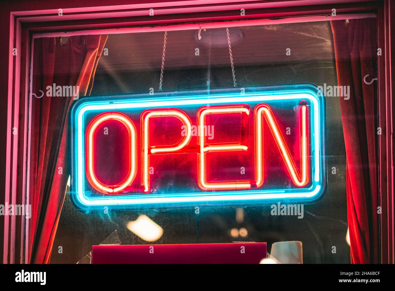 Bright neon open sign hanging in a shop window Stock Photo - Alamy