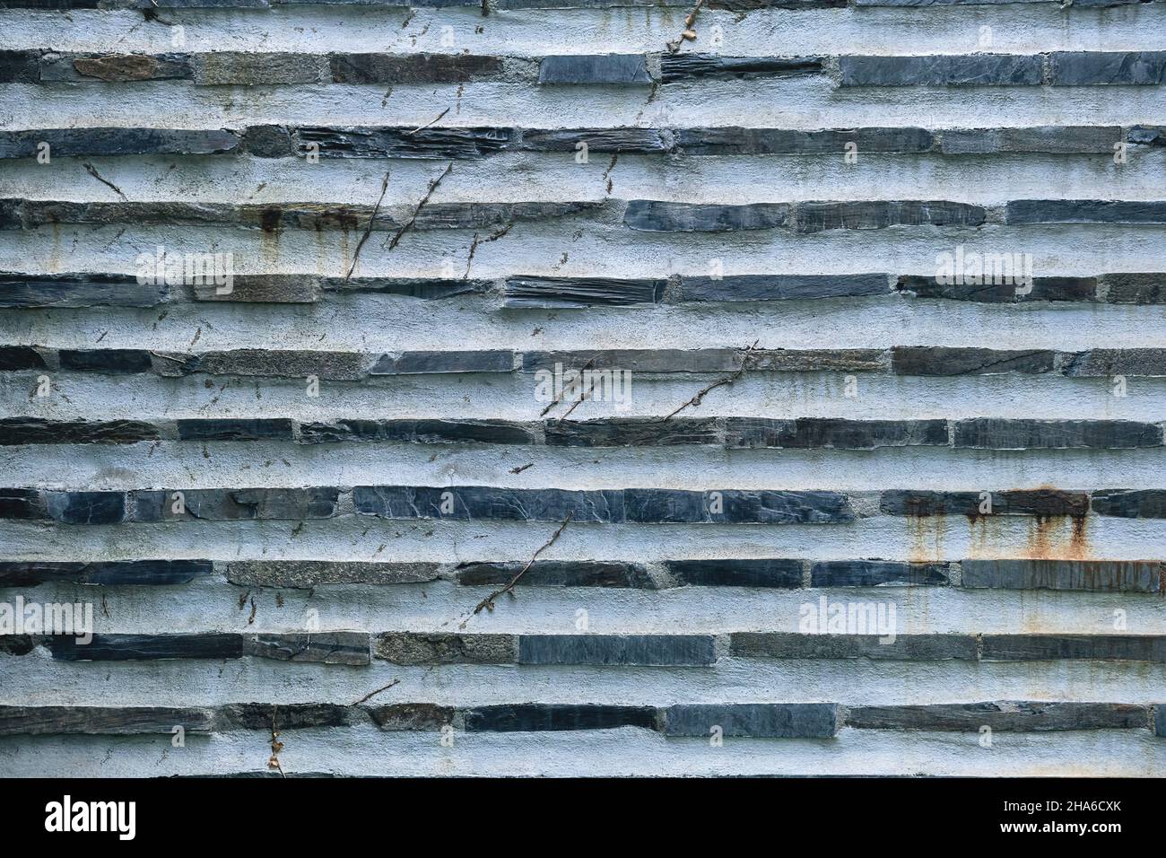 Traditional slate stone bricks and white concrete wall, mountain ...