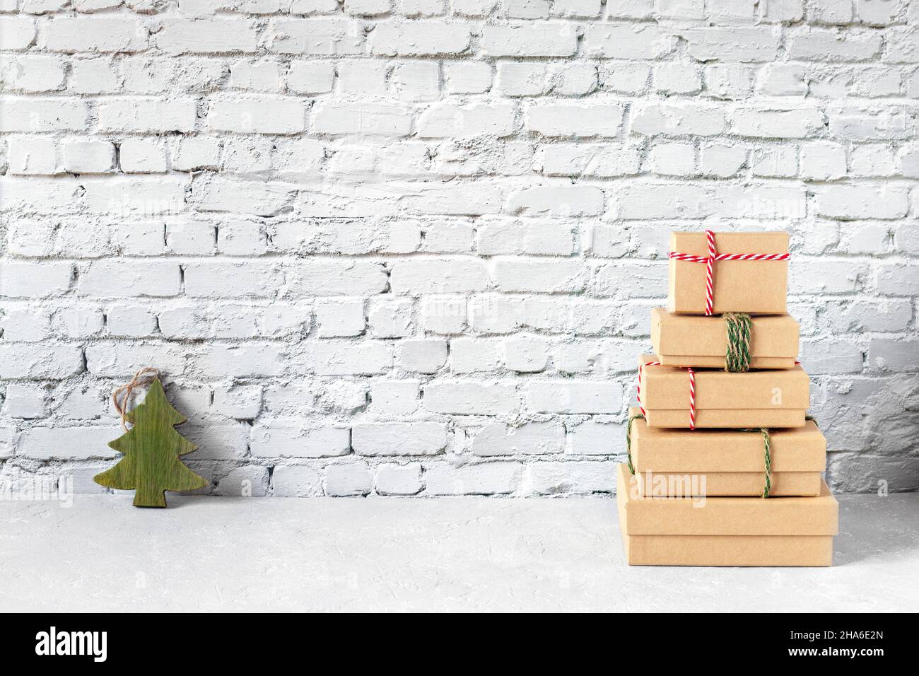 Craft paper gift boxes in a form of New Year tree with a small wooden ...