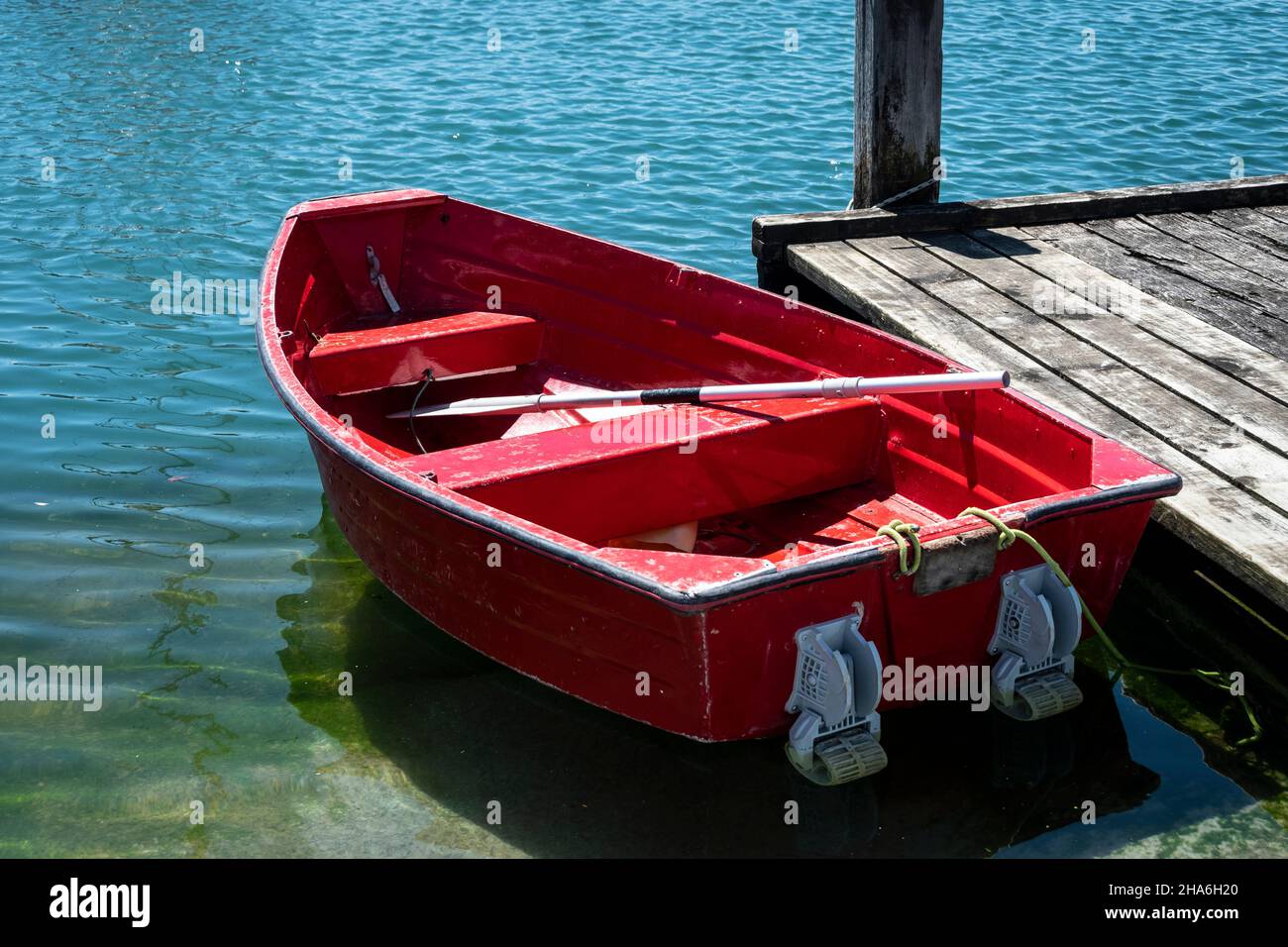 Red dingy alongside wharf, Boat Harbour, Wellington, North Island, New ...