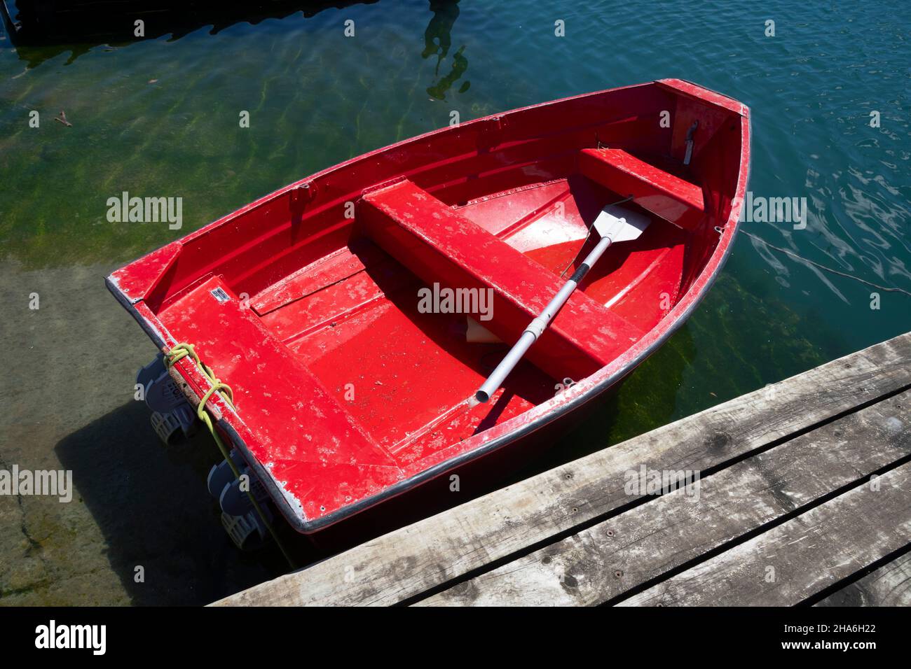 Red dingy alongside wharf, Boat Harbour, Wellington, North Island, New ...