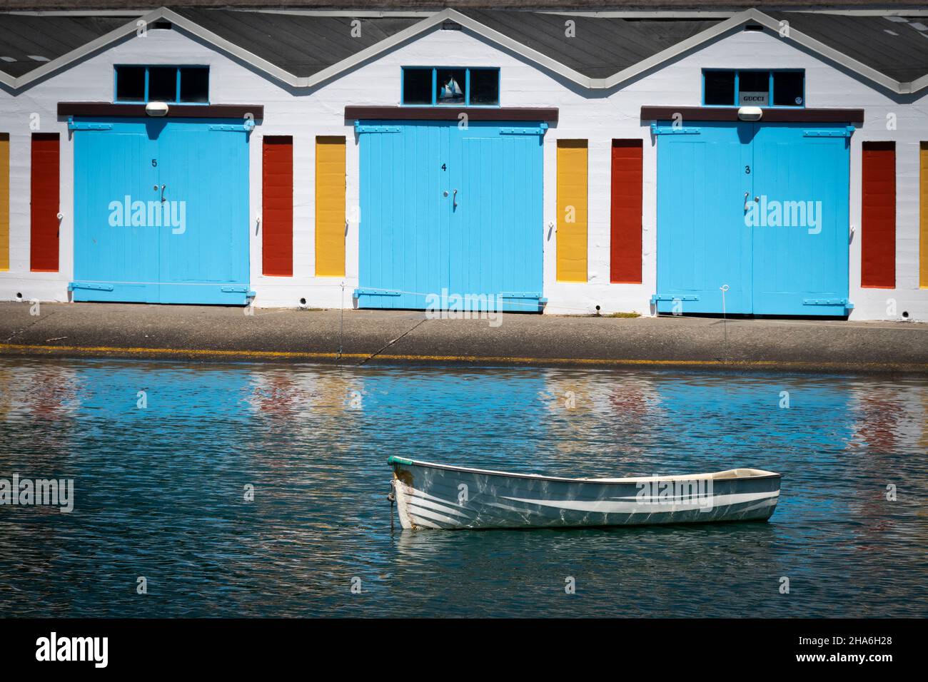 Dingy moored in front of Blue boat sheds, Boat Harbour, Wellington ...