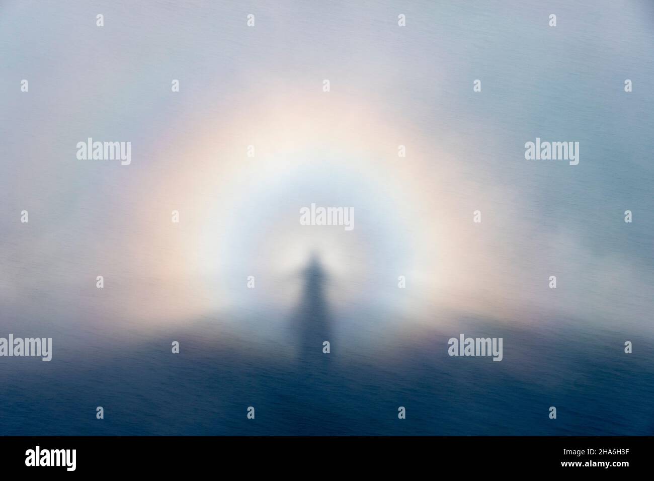 Shadow of person on sea fog creating a rainbow. Known as the brocken ...