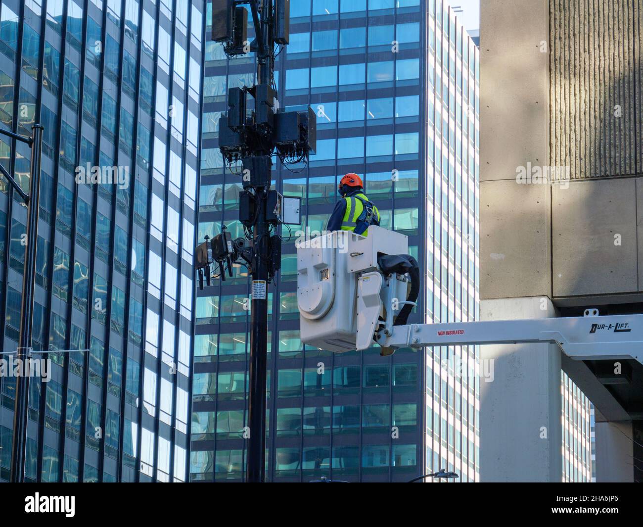 Technician servicing cellular antennas on light pole. Chicago, Illinois ...