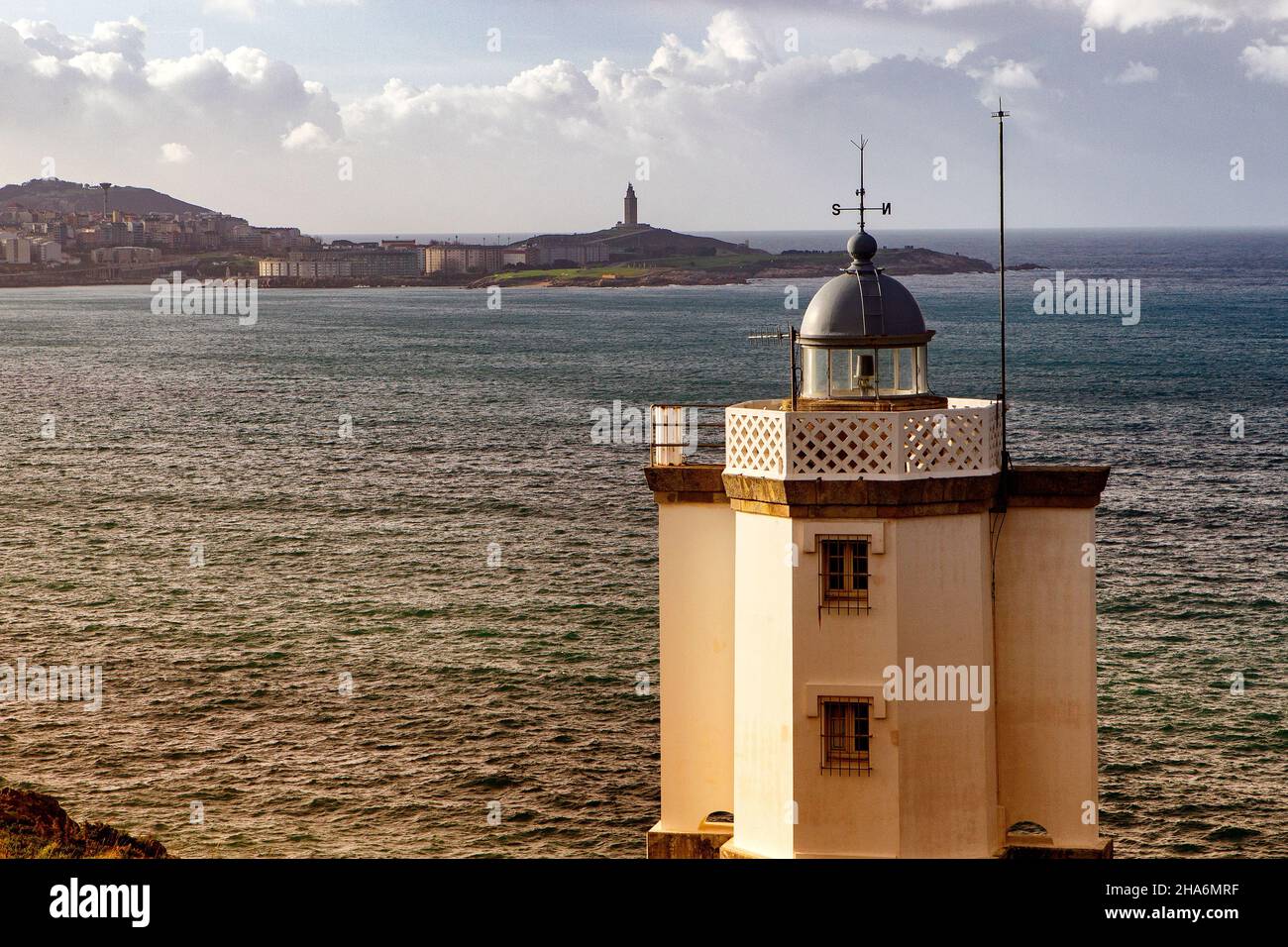 Small lighthouse at the cape of Mera with the Roman lighthouse Torre de ...