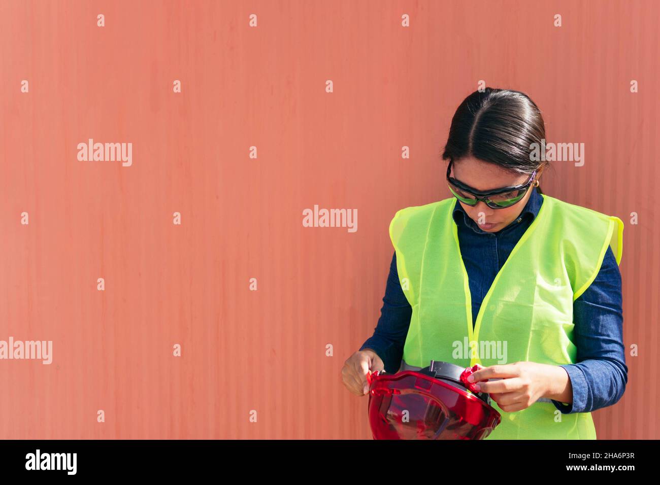Female worker in a hard hat factory Stock Photo - Alamy