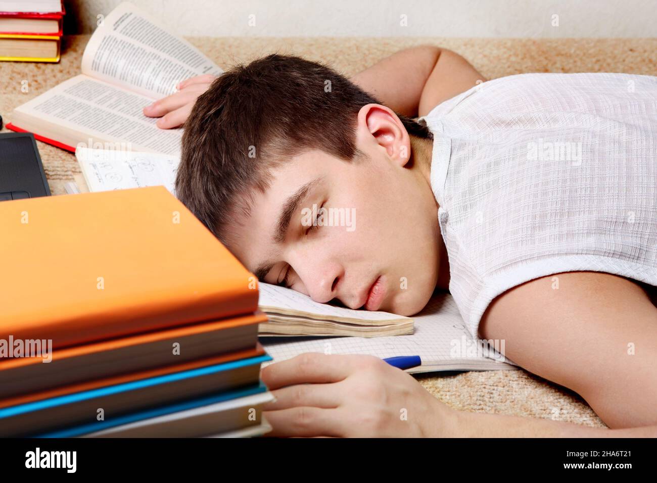 Tired Teenager sleeping with the Books on the Sofa Stock Photo - Alamy