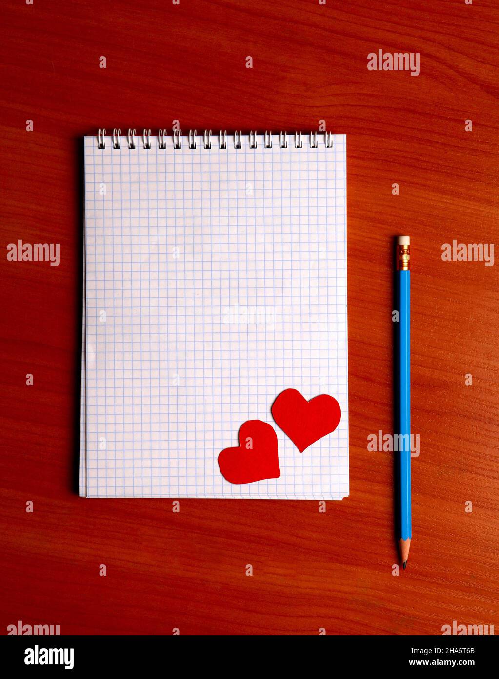 Blank Writing Pad with Heart Shapes and Pencil On The Table Stock Photo ...