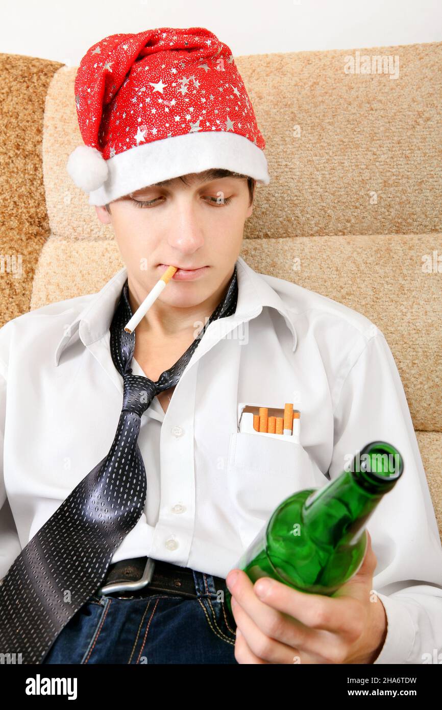 Teenager in Santa Hat with Bottle of the Beer smoking Cigarette Stock ...