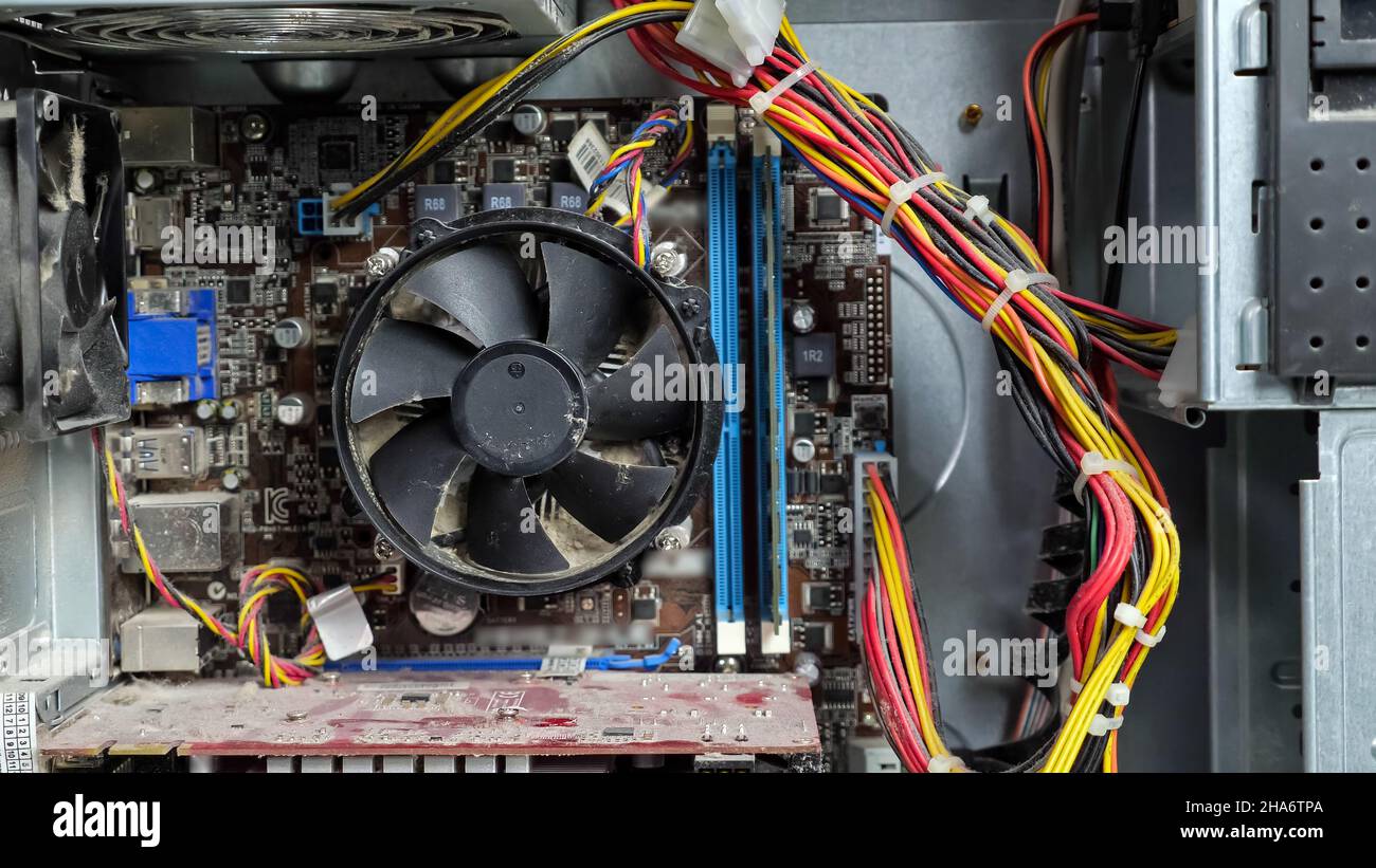 Disassembled dusty system unit. Man's hand scrolls a fan Stock Photo ...