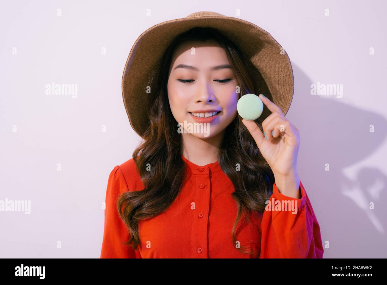 Portrait of a beautiful young woman wearing red dress standing isolated ...