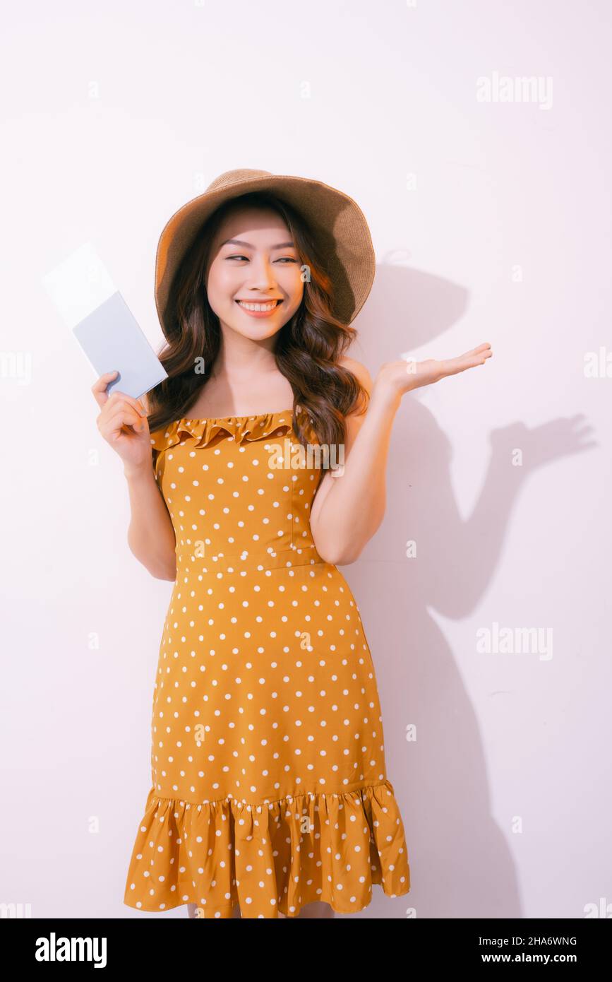 Travel concept portrait of smiling woman holding passport with ticket ...