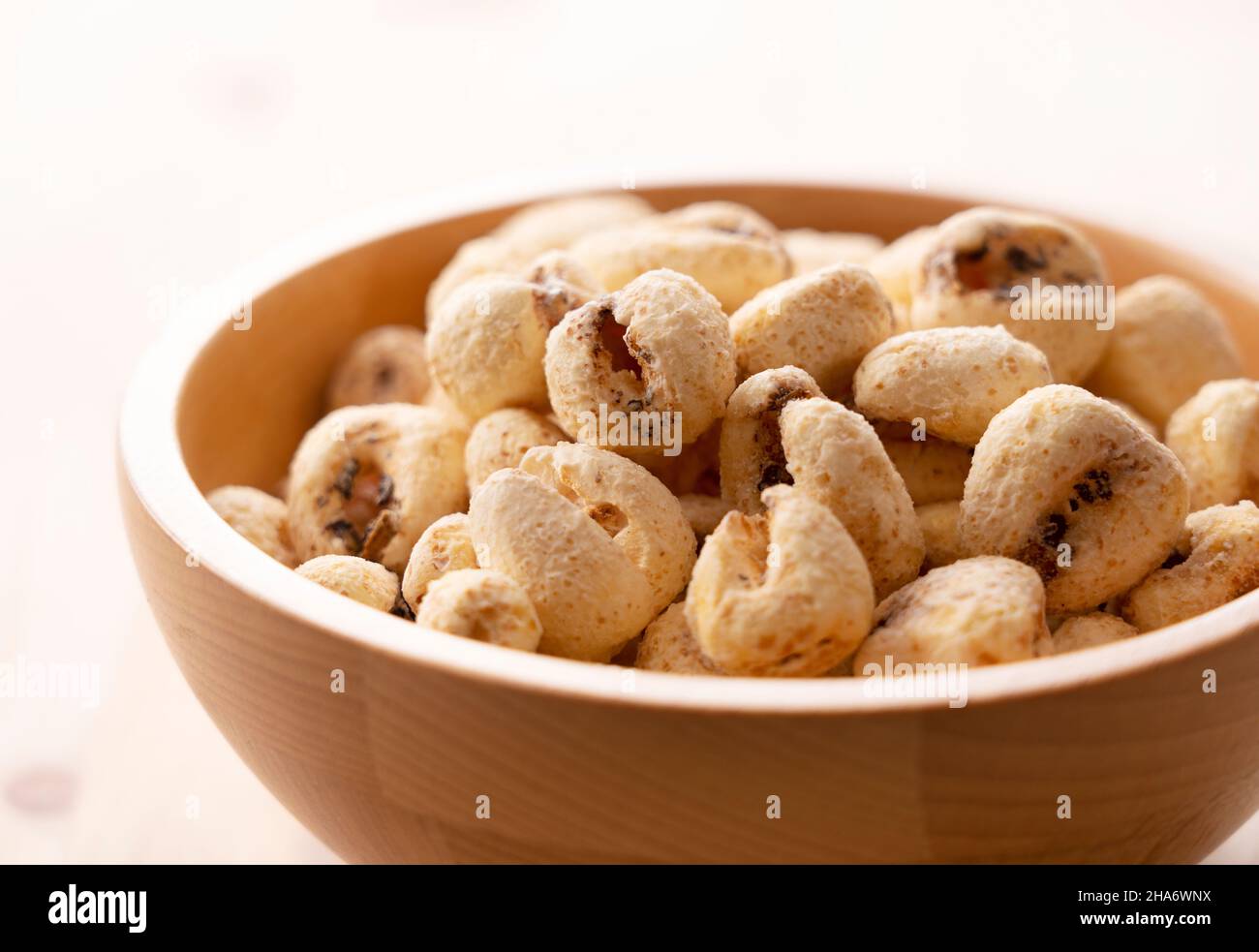 Jumbo corn baked goods in a wooden bowl on a white background Stock ...