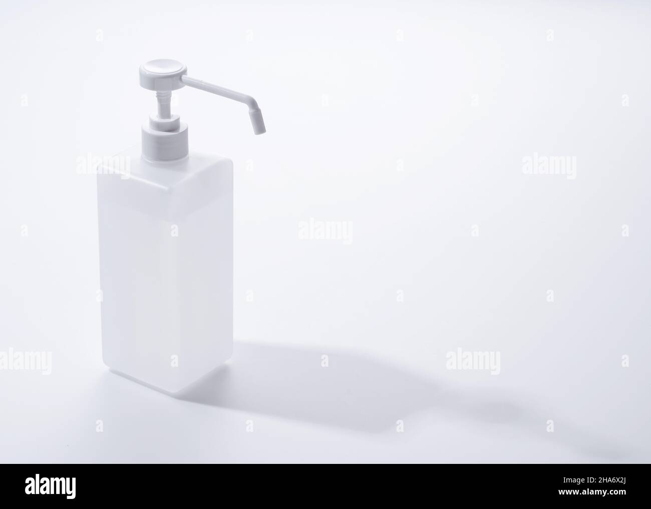 Bottle of alcohol sanitizer spray placed on white background in copy ...